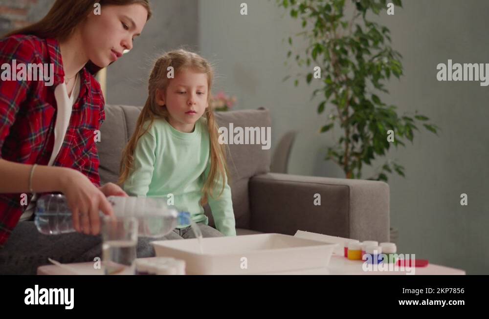 Girl pours water into tray to teach sister Ebru drawing Stock Video ...