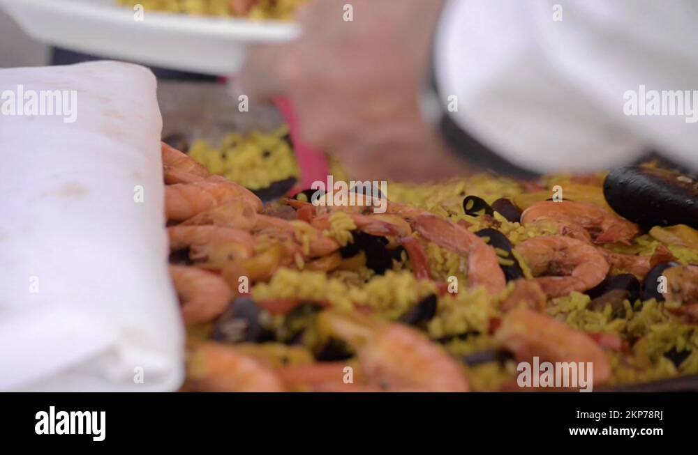 People serving paella on their plates at a buffet Stock Video Footage ...