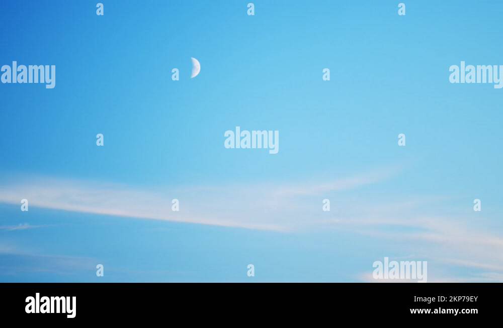 Dreamy scenery of half moon in sky during stunning sunset. Waxing ...