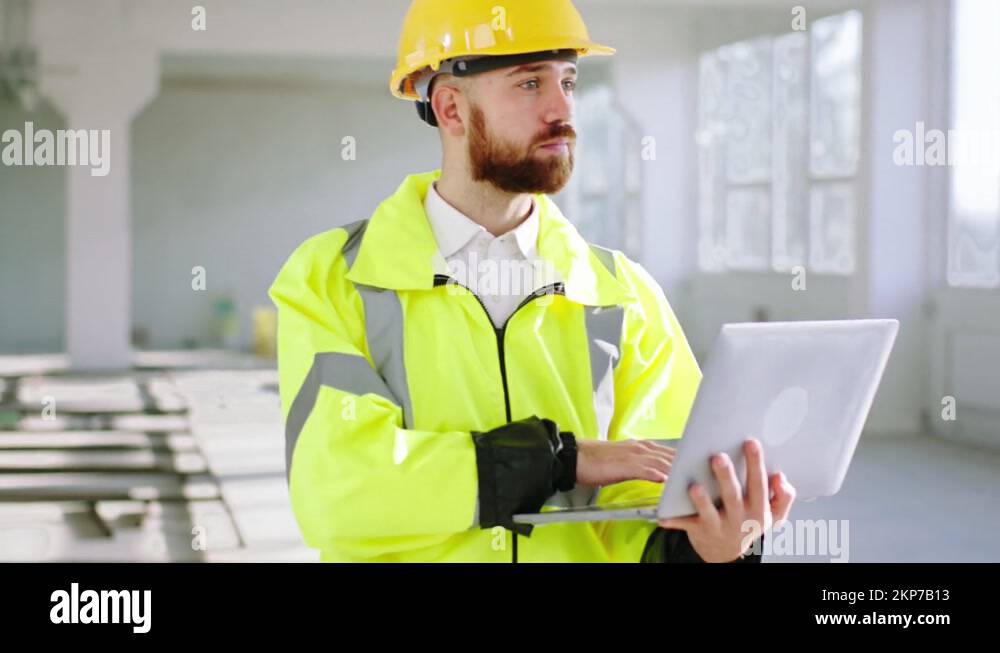 Charismatic engineer man at construction site in a special uniform ...