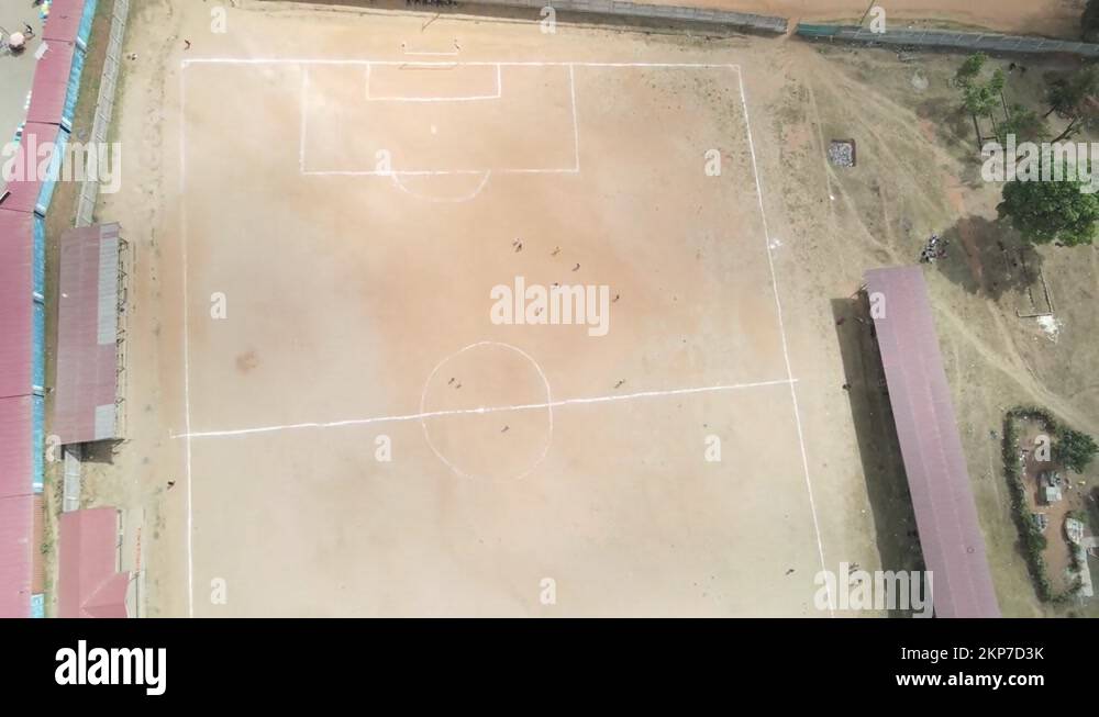 children playing football on a dirt field. overview of simple sports ...