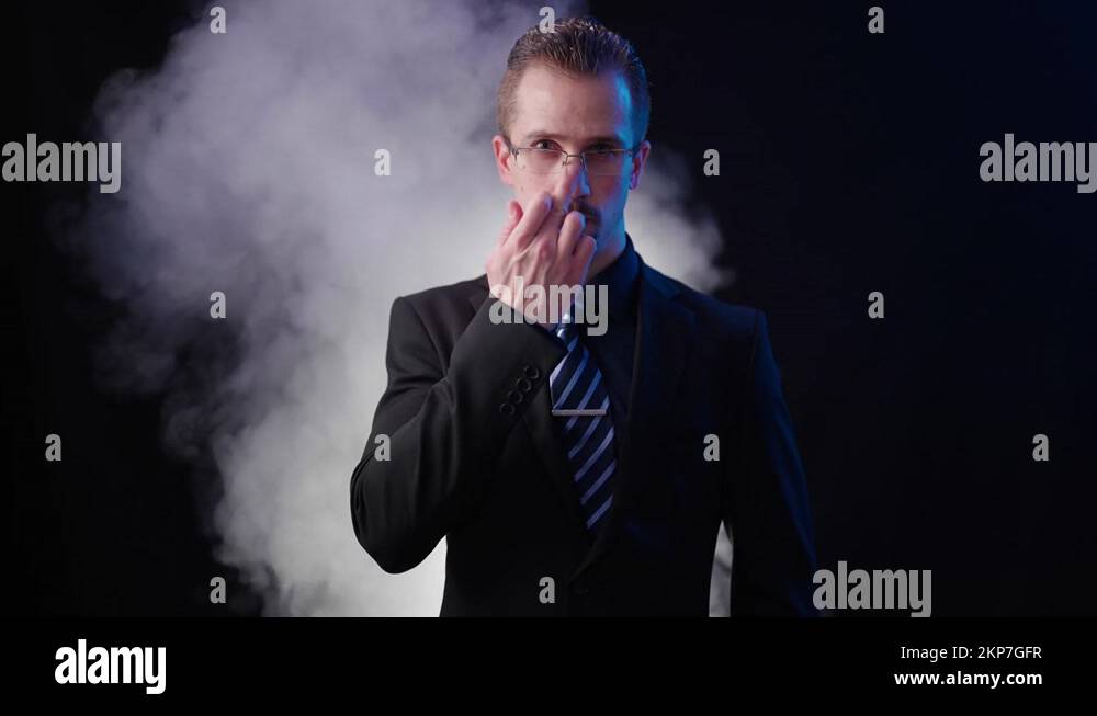 Male businessman on black background fix glasses with middle finger ...