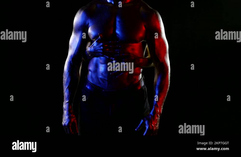 the middle plan of a muscular male torso with golden metallic skin. the ...