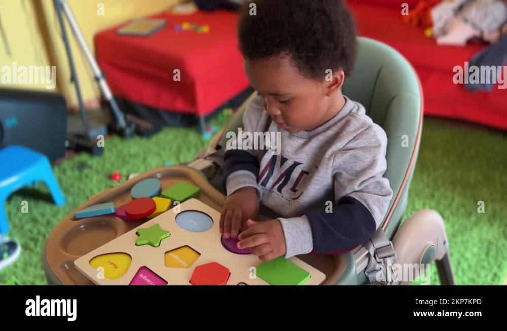 Two year old baby playing happy and funny learning colours and shapes ...