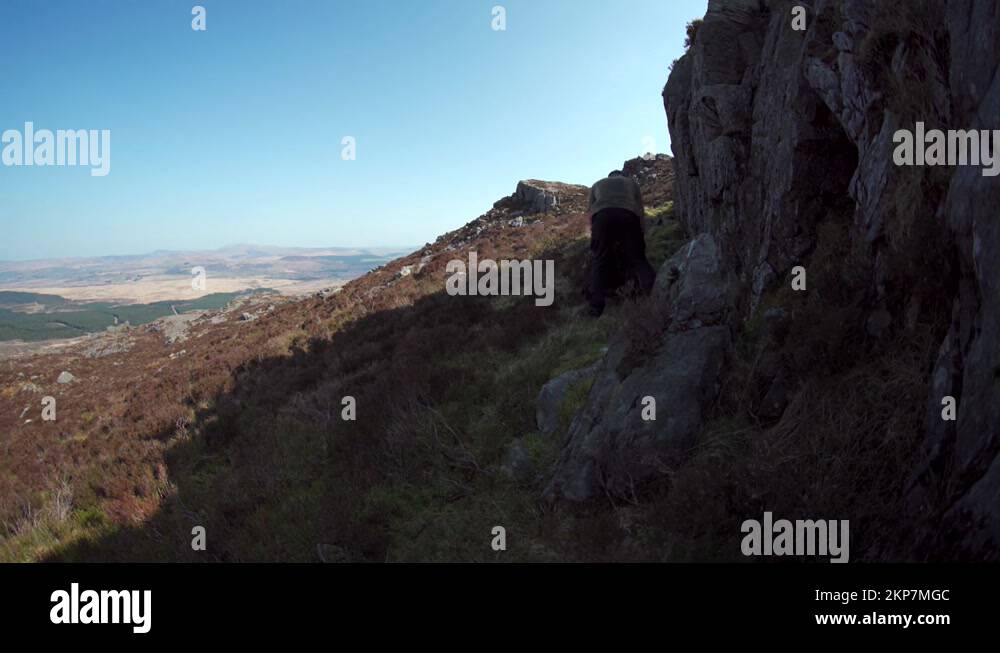 A hiker sitting down in shade to rest and read a map Stock Video ...