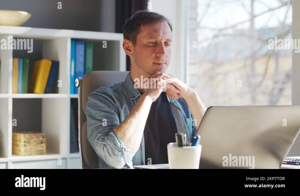 Young male entrepreneur works at home office at the computer. Workplace ... Young male entrepreneur works at home office at the computer. Workplace ...