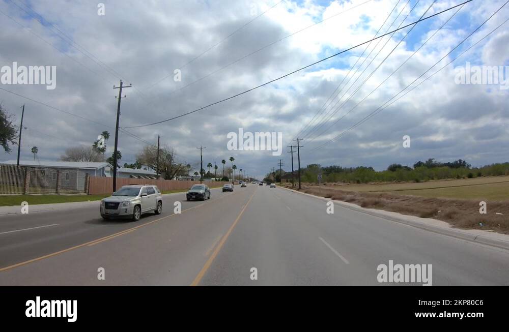 POV driving on a four lane road and turning into a gated community in ...