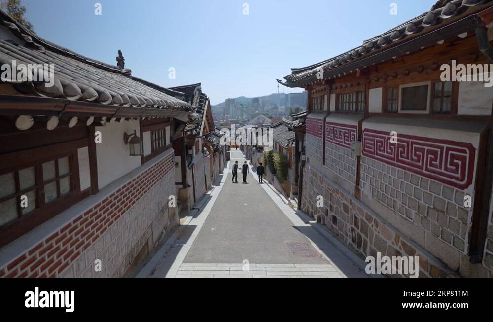 Bukchon Hanok Village in Seoul, people in facemasks walking up the ...