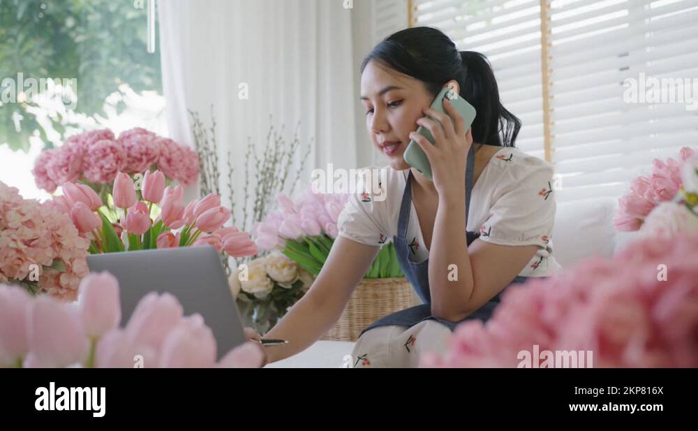 Telesale phone call checking stock by Gen Z SME owner at home office Stock Video Footage - Alamy