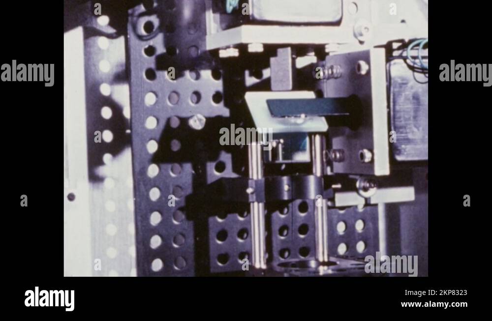 1980s: Laser testing table. Red laser light. Scientist setting up ...