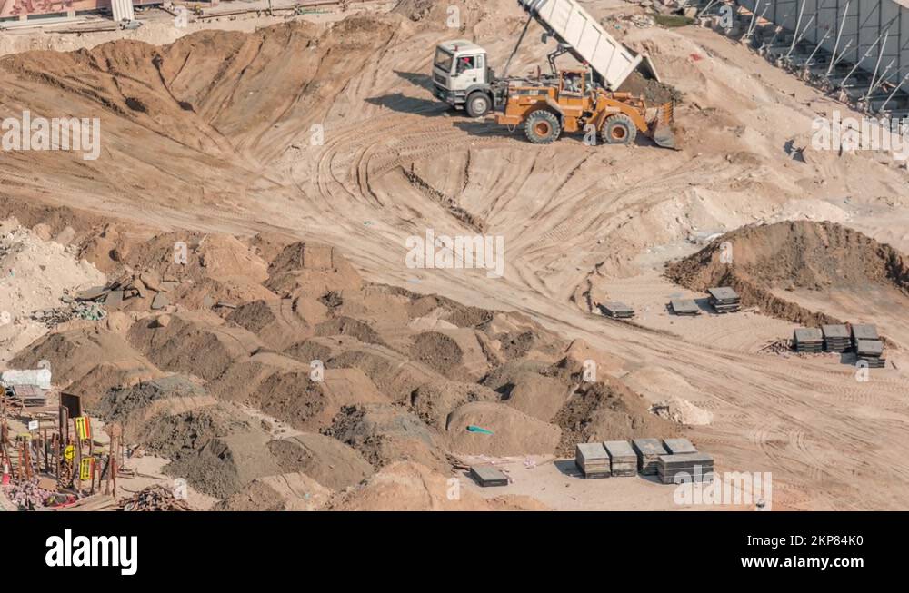 Wheel loader machine unloading sand at eathmoving works in construction ...