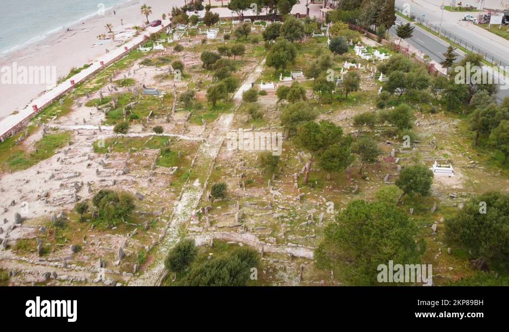 Graveyard near seashore. Old cemetery with white tombstones and green ...