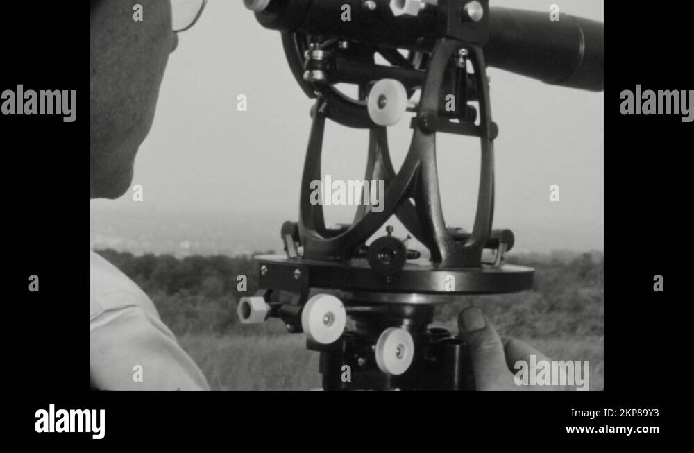 1960s: Hands adjusting survey equipment. Lines on map. Hand writing on ...