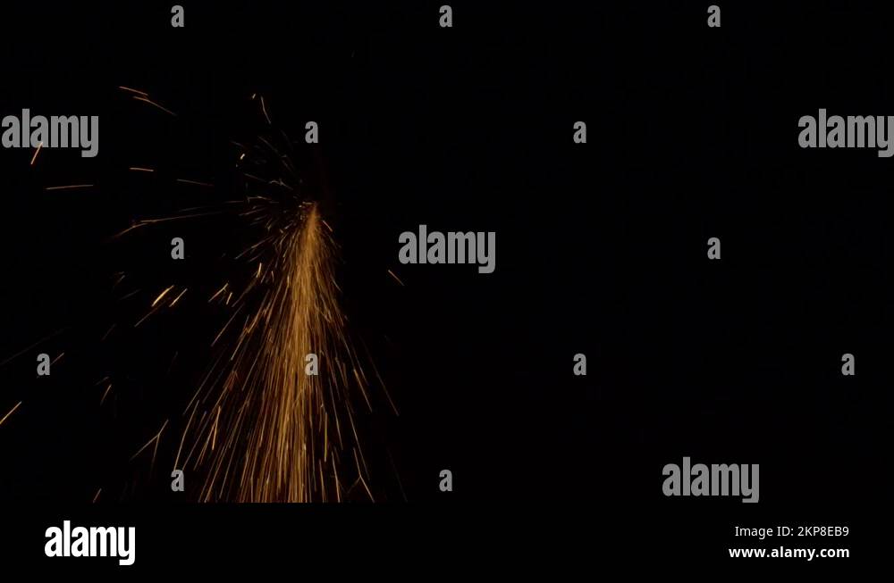 Angle grinder applied to metal, small metal particles are ejected as ...