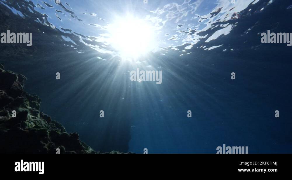 sun ray beam underwater waves on surface water slow ocean scenery ...