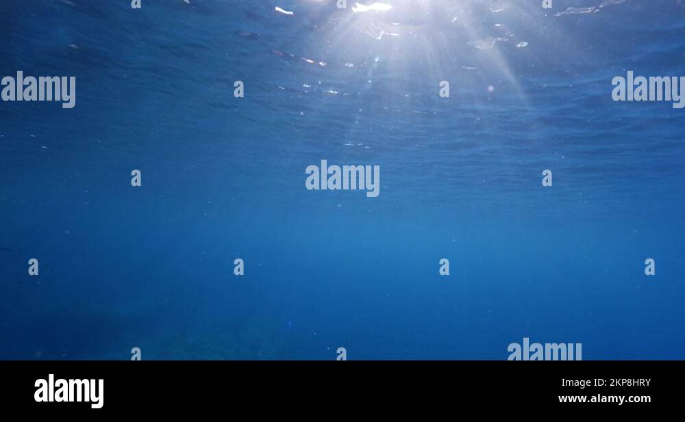 sun ray beam underwater waves on surface water slow ocean scenery ...