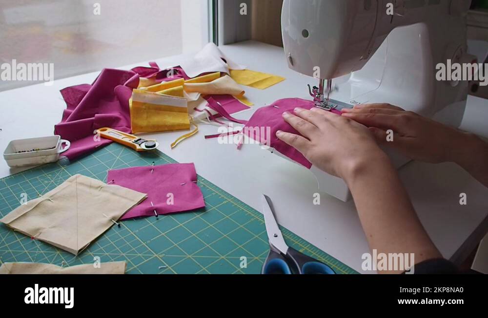 Woman working on sewing machine, messy work table background Stock ...