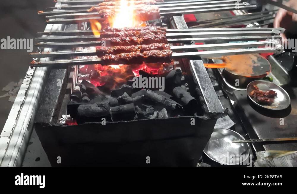 Close up of mutton seekh kabab being amazingly cooked over a coal ...