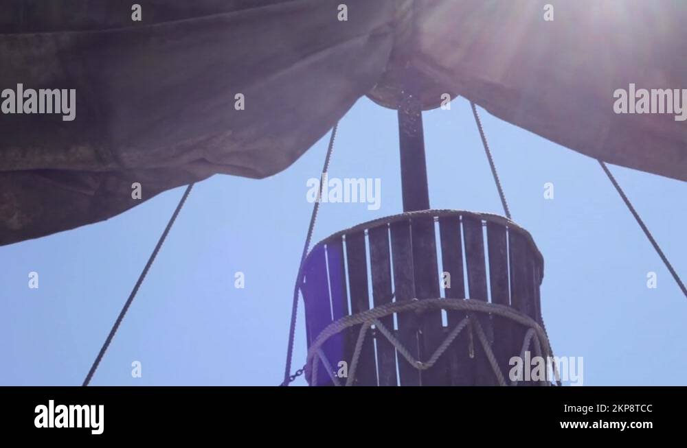 Crow's nest and sails on a pirate ship sailing at sea. Ropes and a a ...
