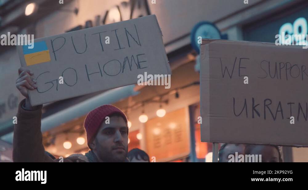 Man marching with sign reading "Putin Go Home" in protest of Russo ...