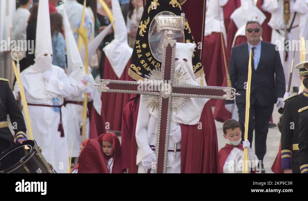 Penitent with the guide cross in a procession of Holy Week. Palm Sunday ...