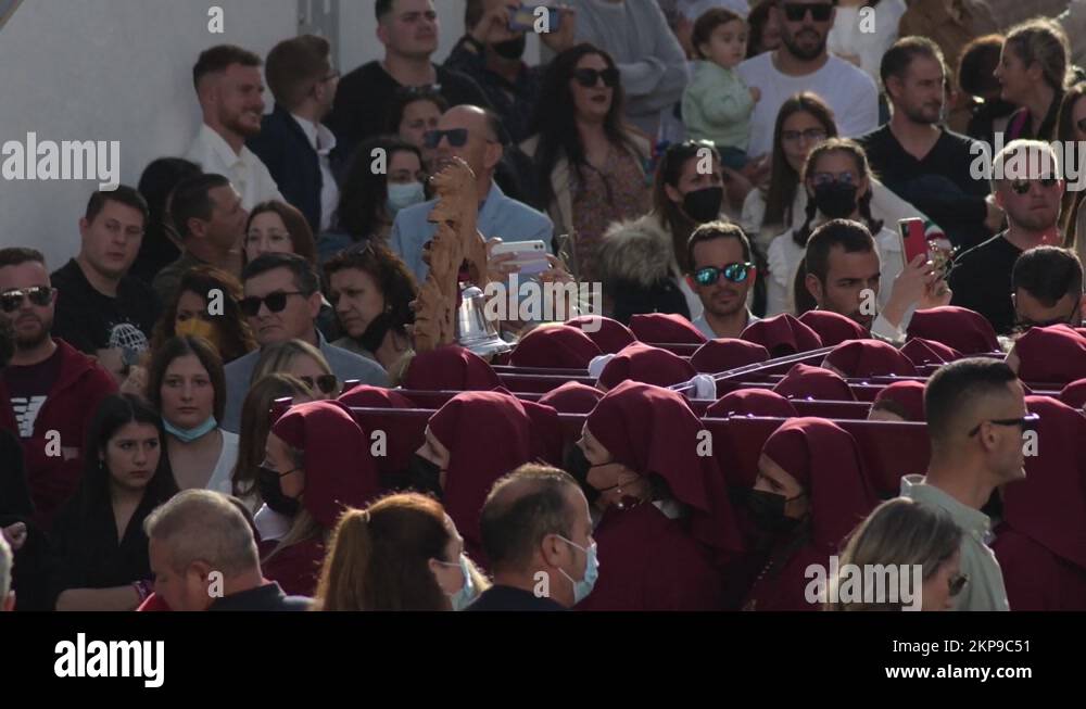 Throne head with women bearers marching between people in holy week ...