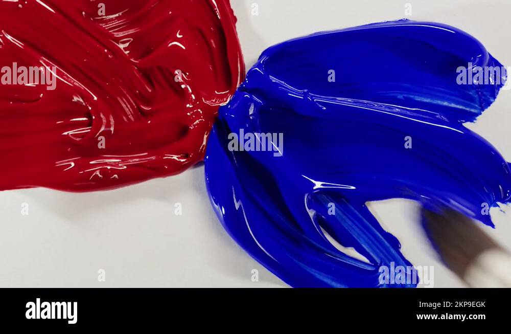 Mixing red and blue paints close-up. Drawing on white paper top view ...