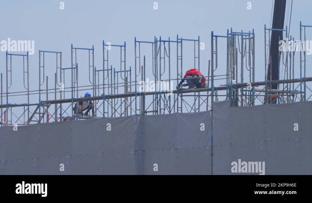 Two Japanese construction workers in full PPE working in the heatwave ...