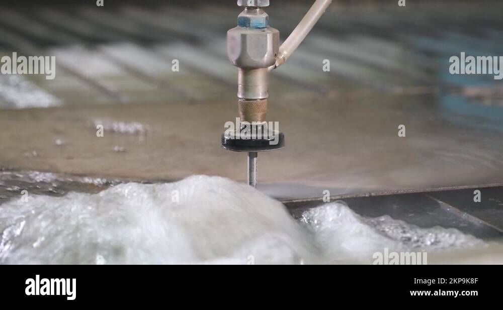 Hydroabrasive high pressure CNC machine is cutting out a shape on a ...