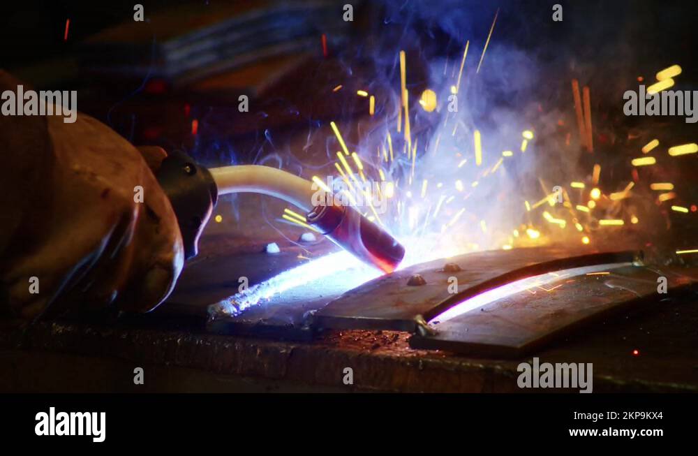 close-up, A man welds plates for body armor from springs. homemade ...
