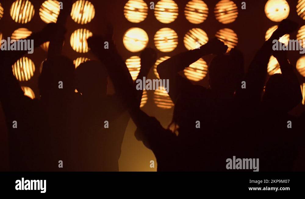 Silhouettes happy people dancing on disco. Active crowd jumping with ...