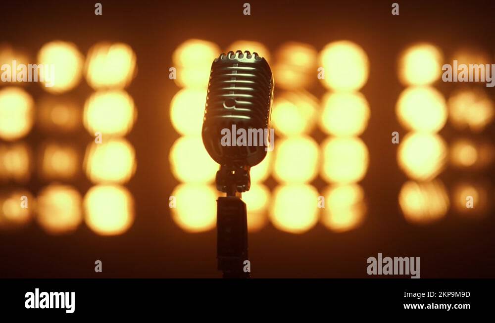 Retro mic placed empty scene illuminated lamps close up. Microphone in ...