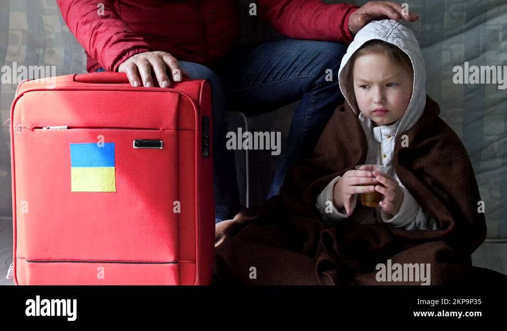 Refugees from Ukraine. An old man and his granddaughter are waiting for ...