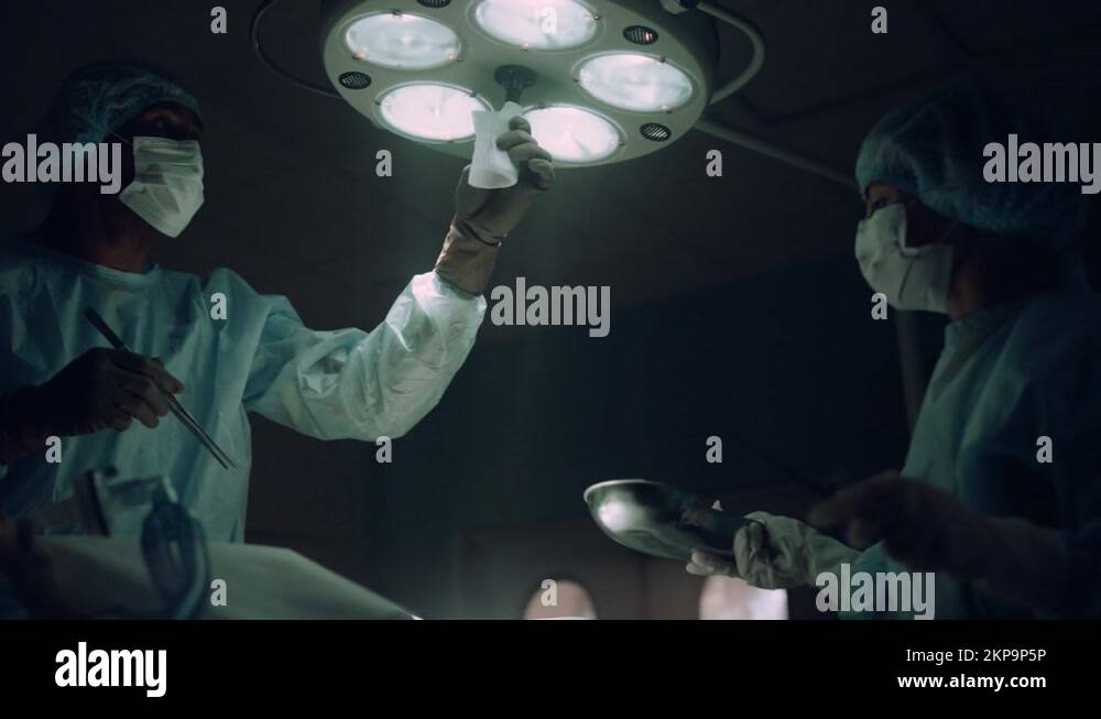 Doctor adjusting surgery lights in operating room. Hospital intensive ...
