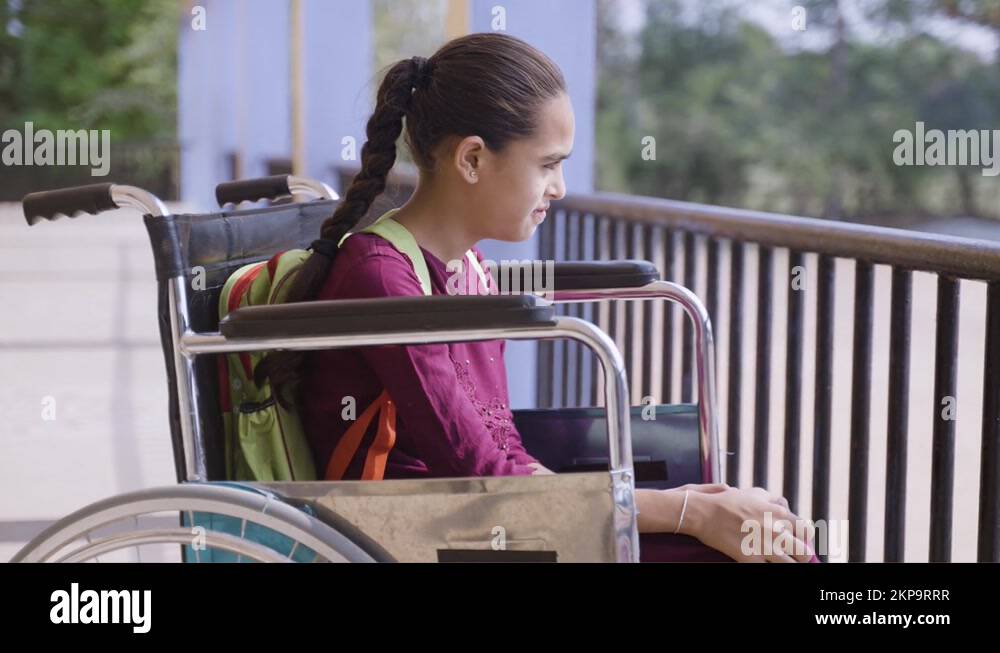 Sad girl kid with disability thinking sitting on wheelchair at school ...