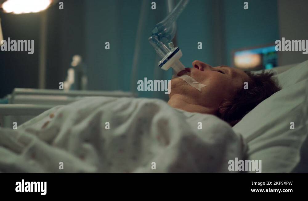 Patient breathing oxygen mask in hospital closeup. Terminally ill ...