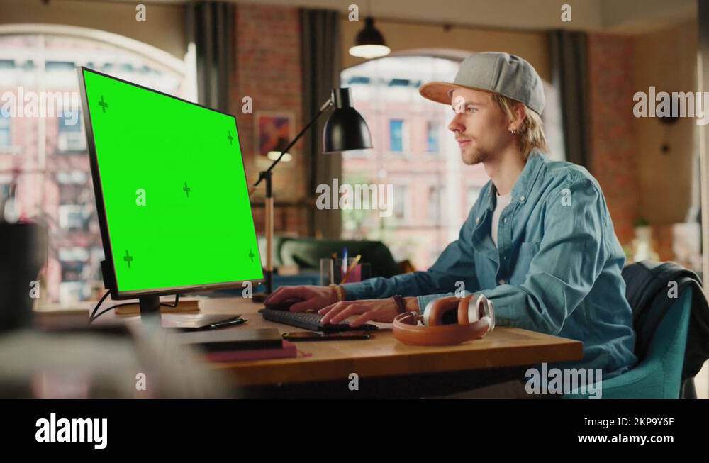 Young Man Using Computer Green Screen in Loft Apartment Stock Video ...