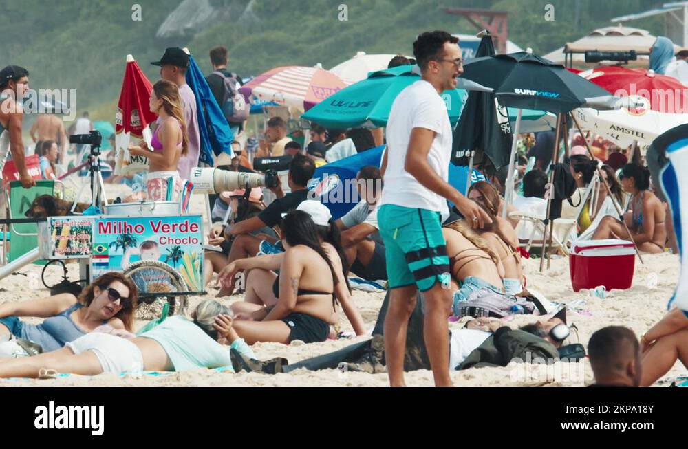 FLORIANOPOLIS, BRAZIL - APRIL 2022: People walk on the Mole beach ...