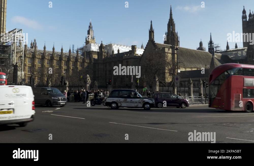 Double Decker Red Bus Taking Left Turn On Parliament Square Past Houses ...