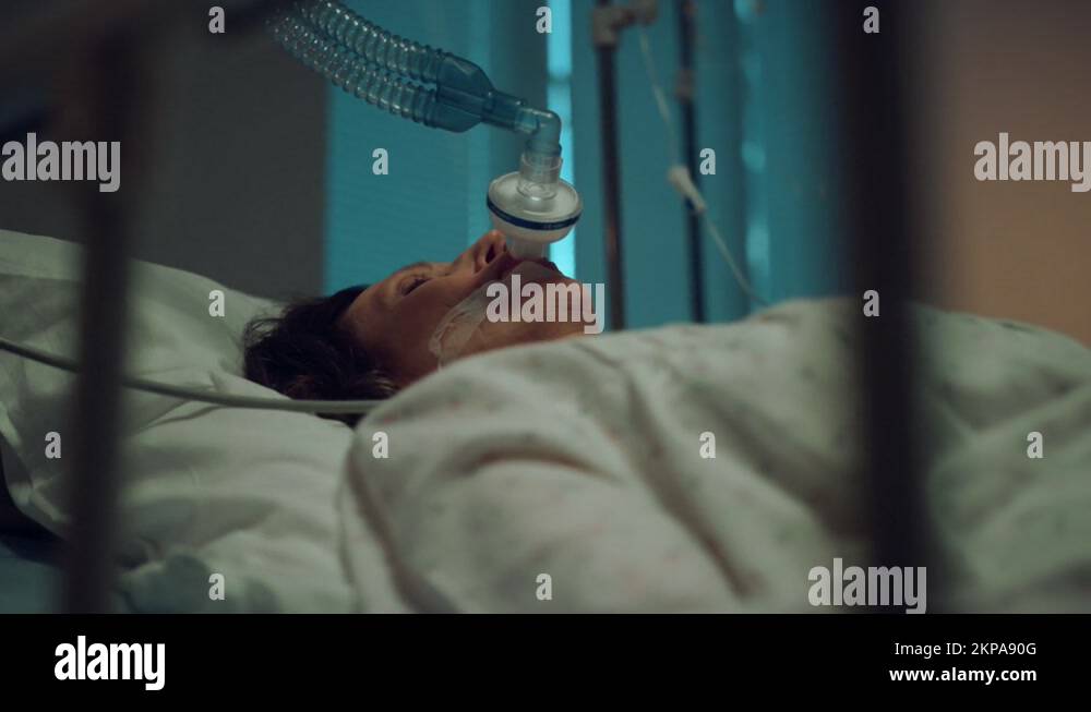 Sick woman wearing oxygen mask portrait. Terminally ill person lying in ...