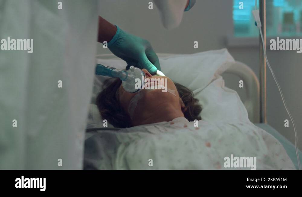 Ill patient breathing oxygen mask hospital bed. Doctor test light ...