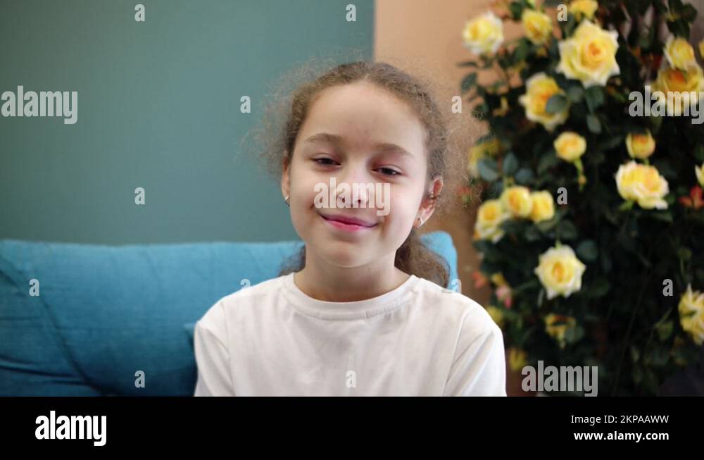 Portrait cute kid child with pretty face sitting on sofa. Funny little ...