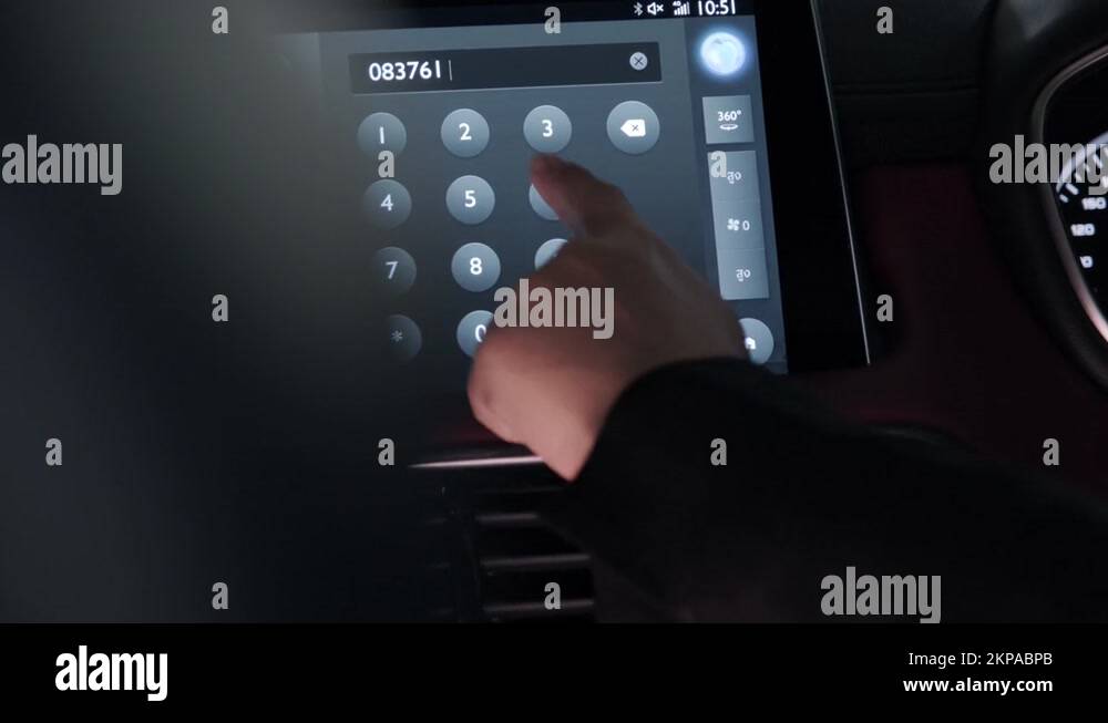 Hand tapping on electronic dashboard of car while having mobile ...