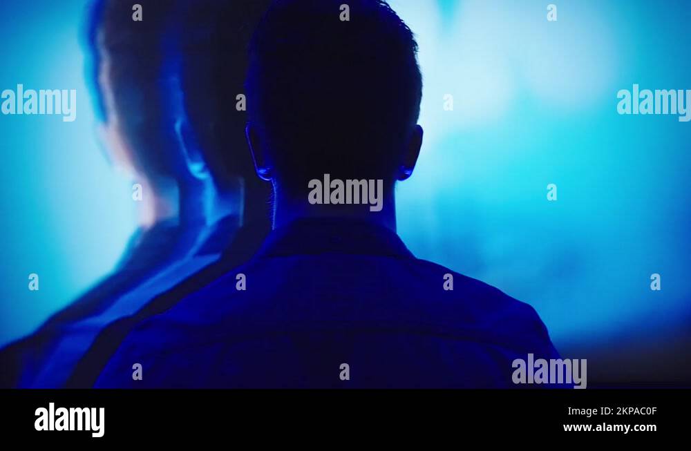 Male silhouette from back move left and right with flash blue and red ...