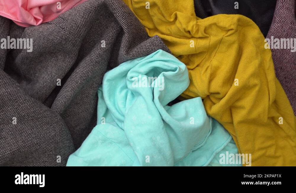 Fast Fashion and Textile Waste. A pile of old used clothes. Recycle ...