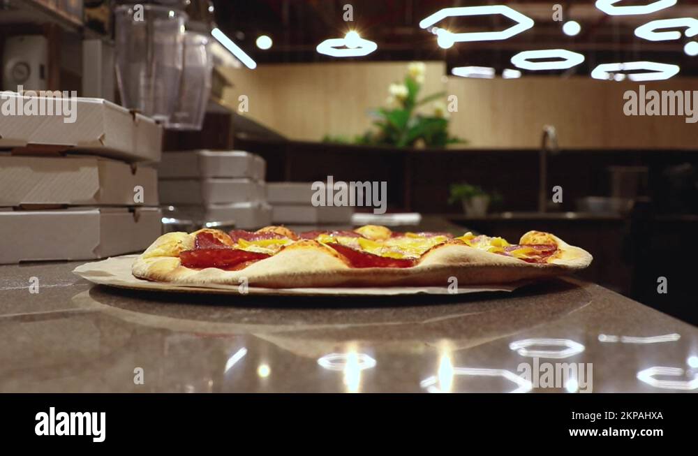 chef puts hot pepperoni pizza with smoke by a shovel on the table Stock ...