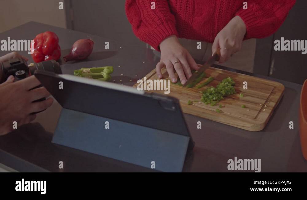 Young woman cooking healthy food, man recording tutorial, top view ...