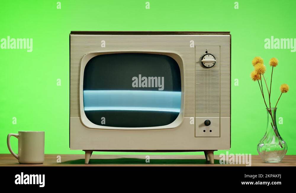 Old television with grey screen on chroma green background. Close-up of ...