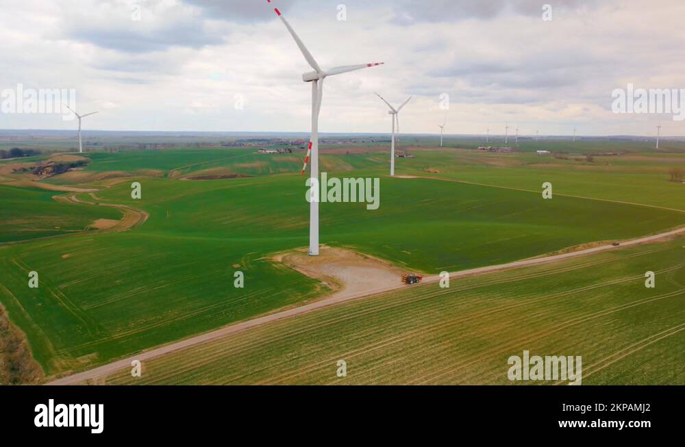 Rotating wind turbine and modern powerful tractor with agro equipment ...