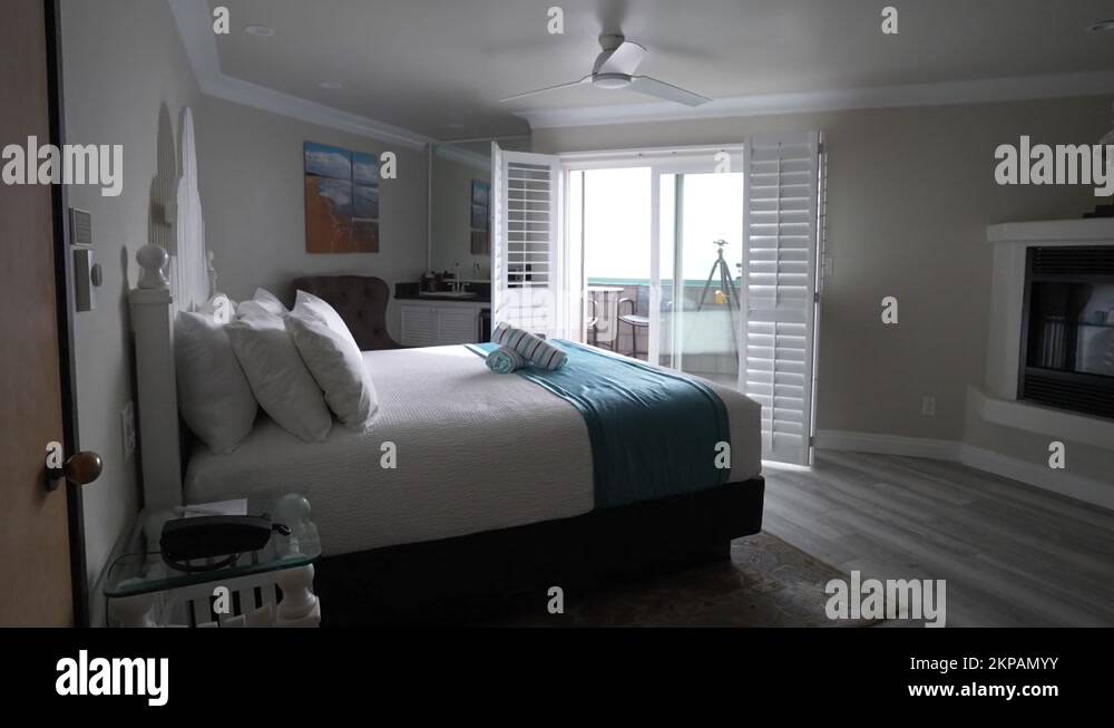 Entering and revealing a welcoming and luxurious master bedroom with a ...